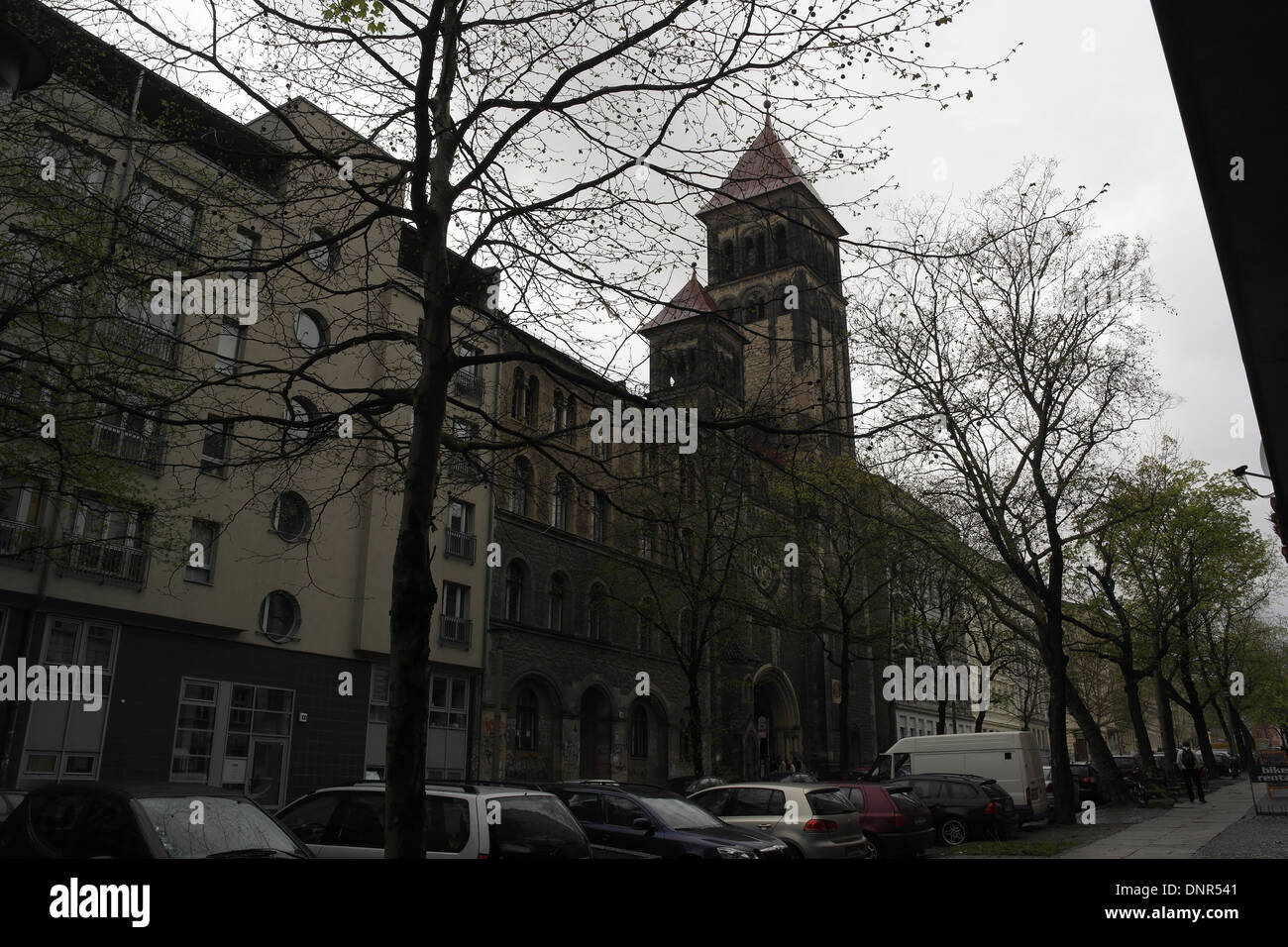 Grey sky upslope view parked cars, pavement trees, apartments, Sacred ...
