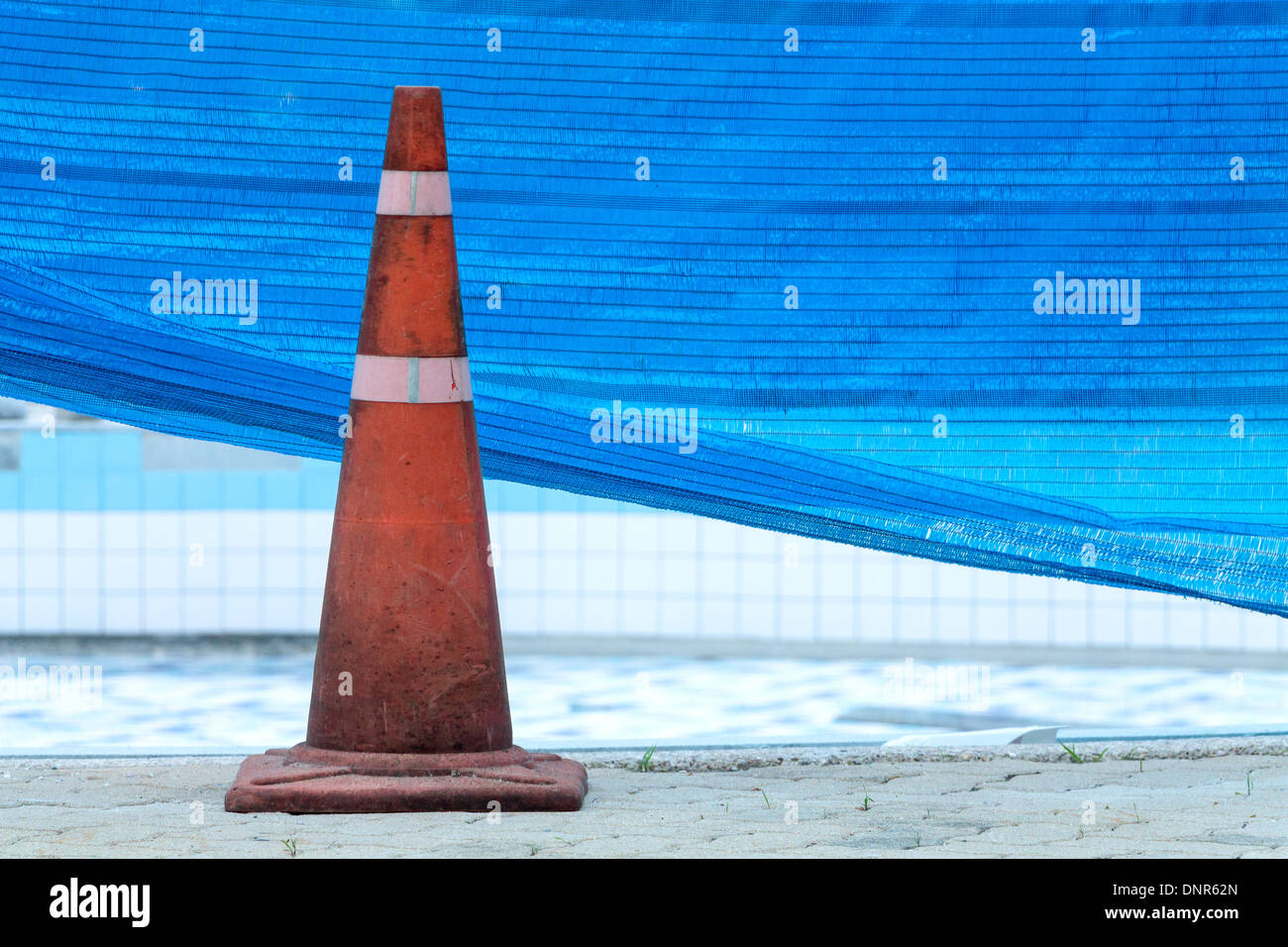 traffic cone near swimming pool repairing works Stock Photo - Alamy