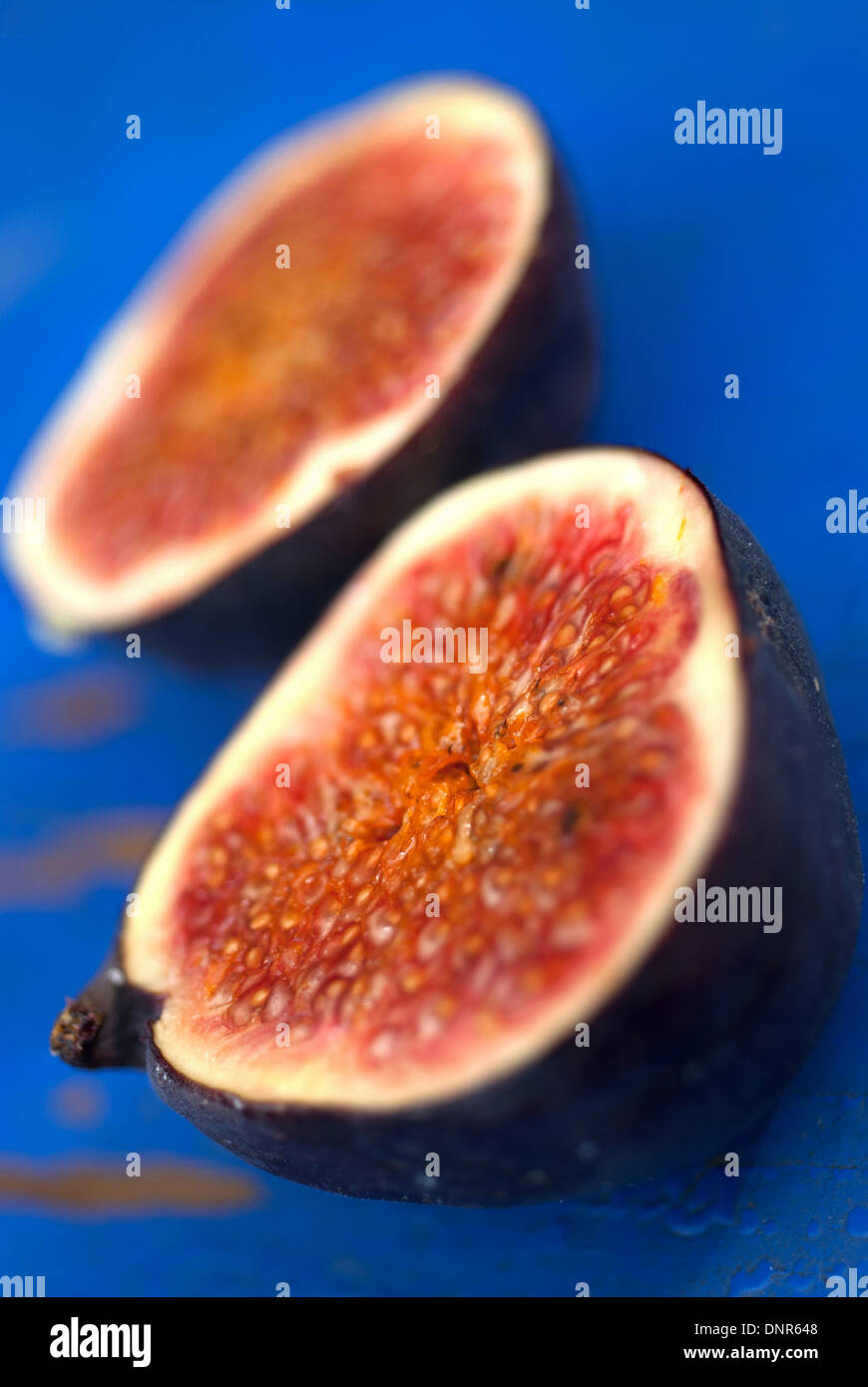 Fresh cut fig on blue painted wood / Exotic fruit Stock Photo - Alamy