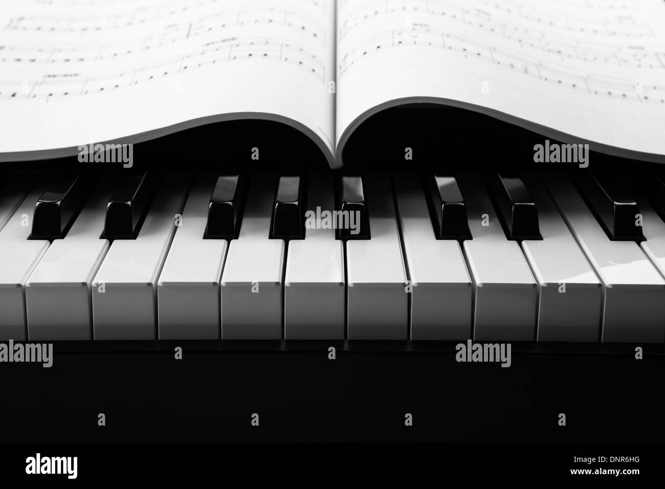 black and white keys of the piano closeup and musical book Stock Photo ...