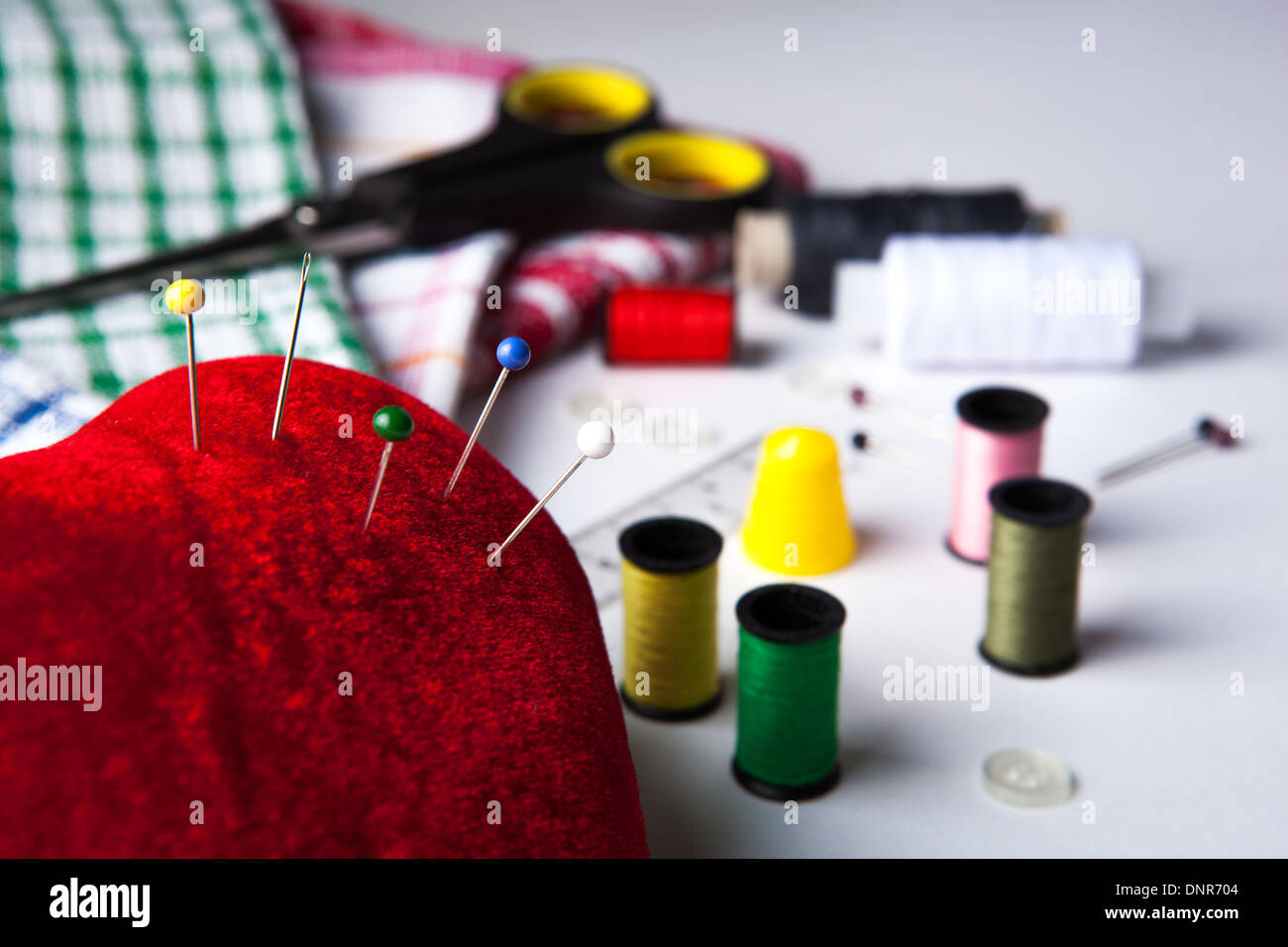needle on a pad and other sewing Stock Photo - Alamy