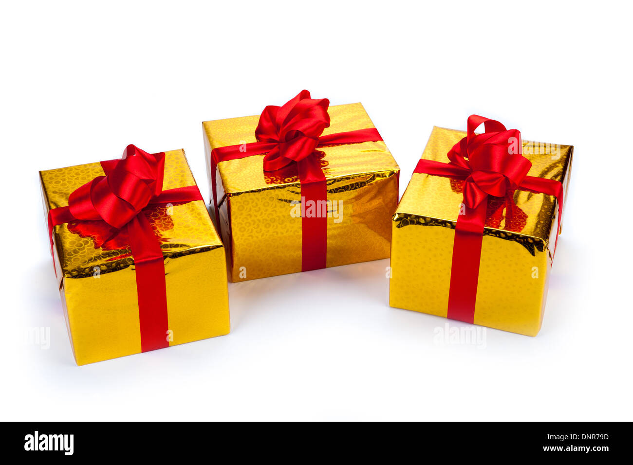Three gold gift boxes on white background Stock Photo - Alamy