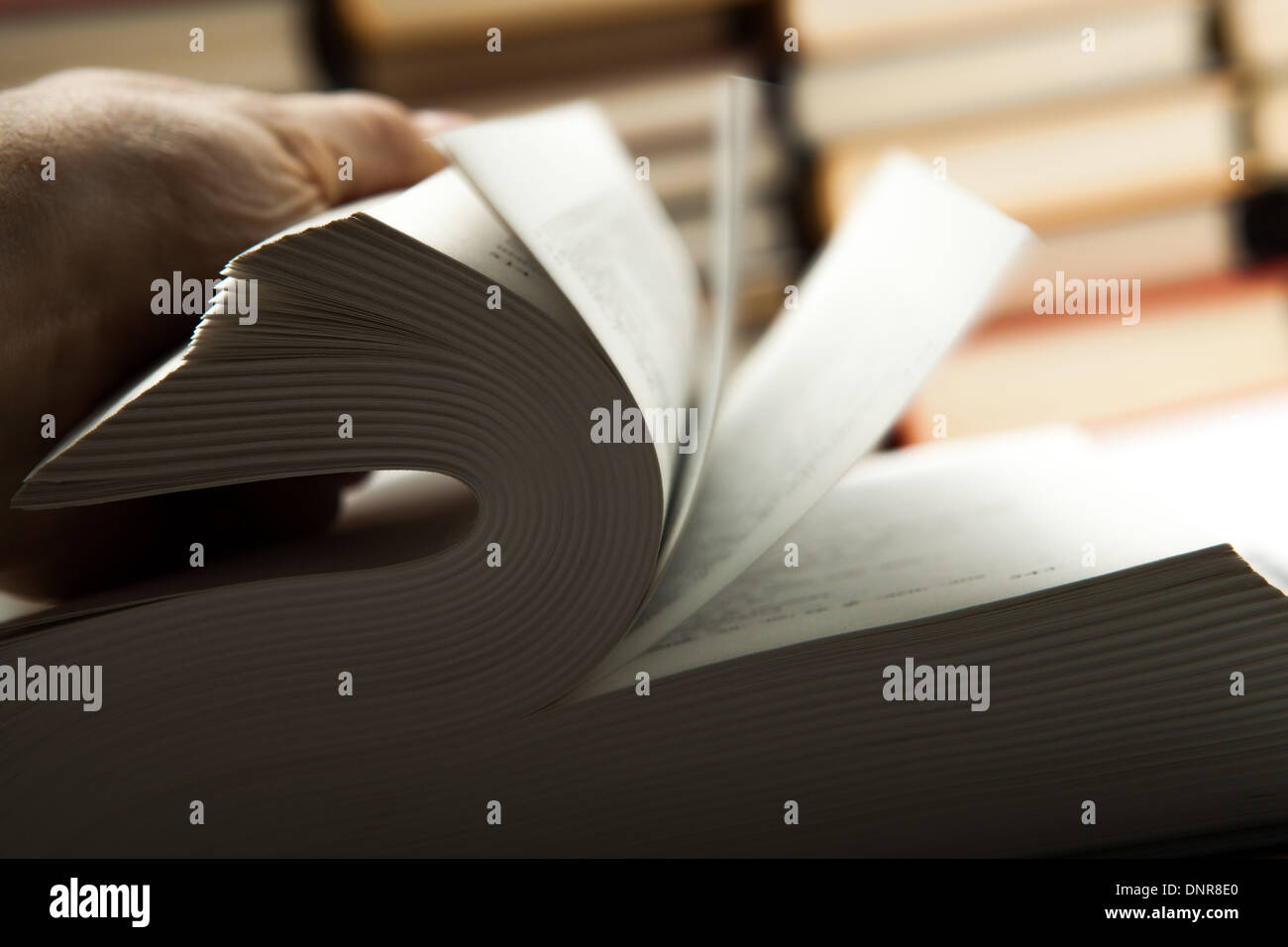 flipping book on with pile of books close up Stock Photo - Alamy
