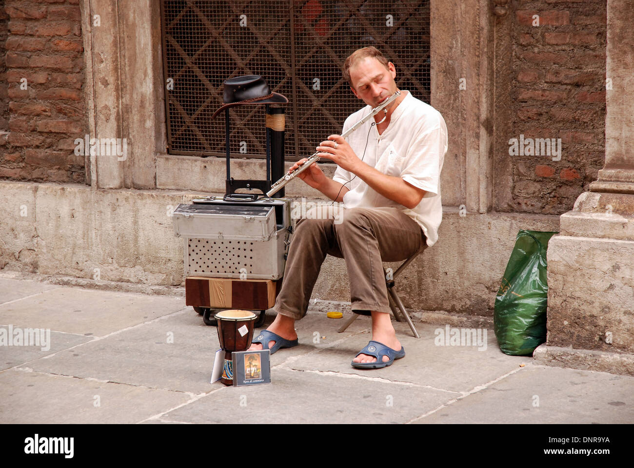 street musician playing flute and busking Stock Photo - Alamy
