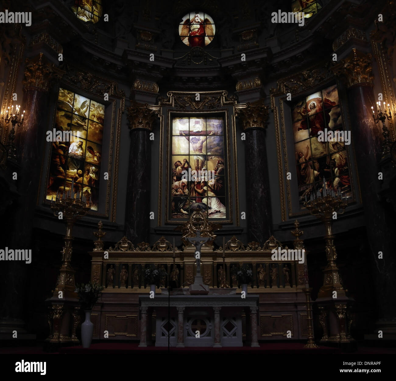 Natural light view marble altar, gilded choir screen, stained glass ...