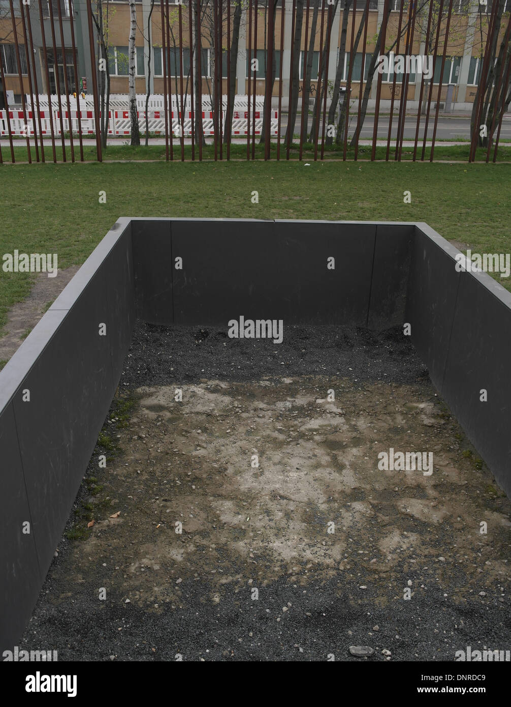 Remains anti-vehicle obstacle in border strip excavation behind metal ...