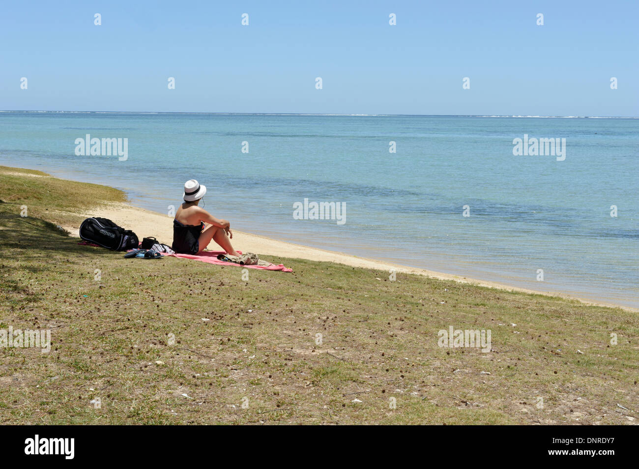 A sunbather at La Prairie beach, Mauritius Stock Photo - Alamy