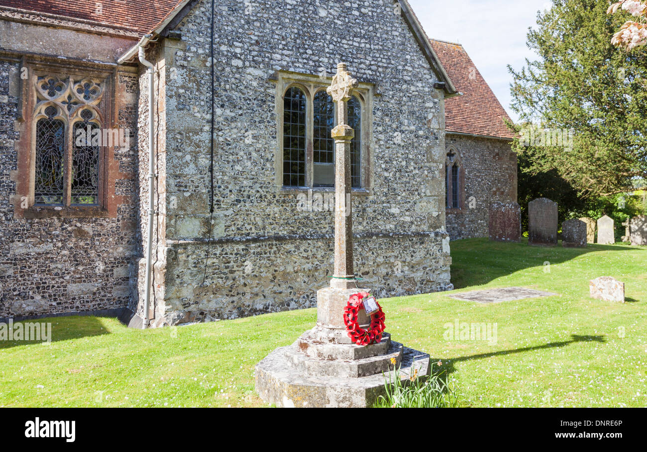 WWI stone cross war memorial and red poppy wreath at St Michael's and ...