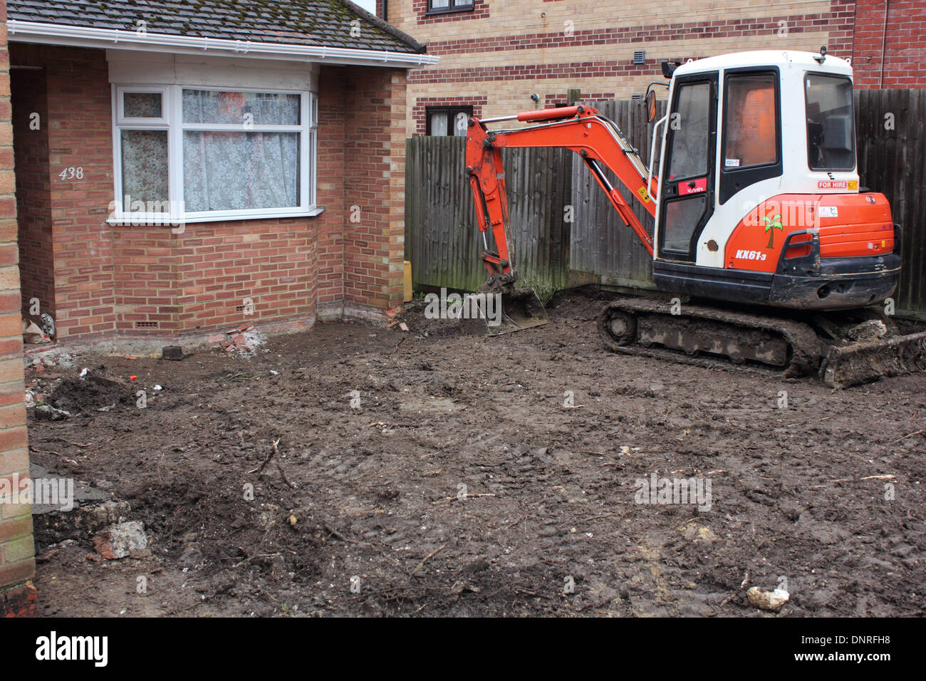 A mini digger being used in the preparation of groundwork for the ...