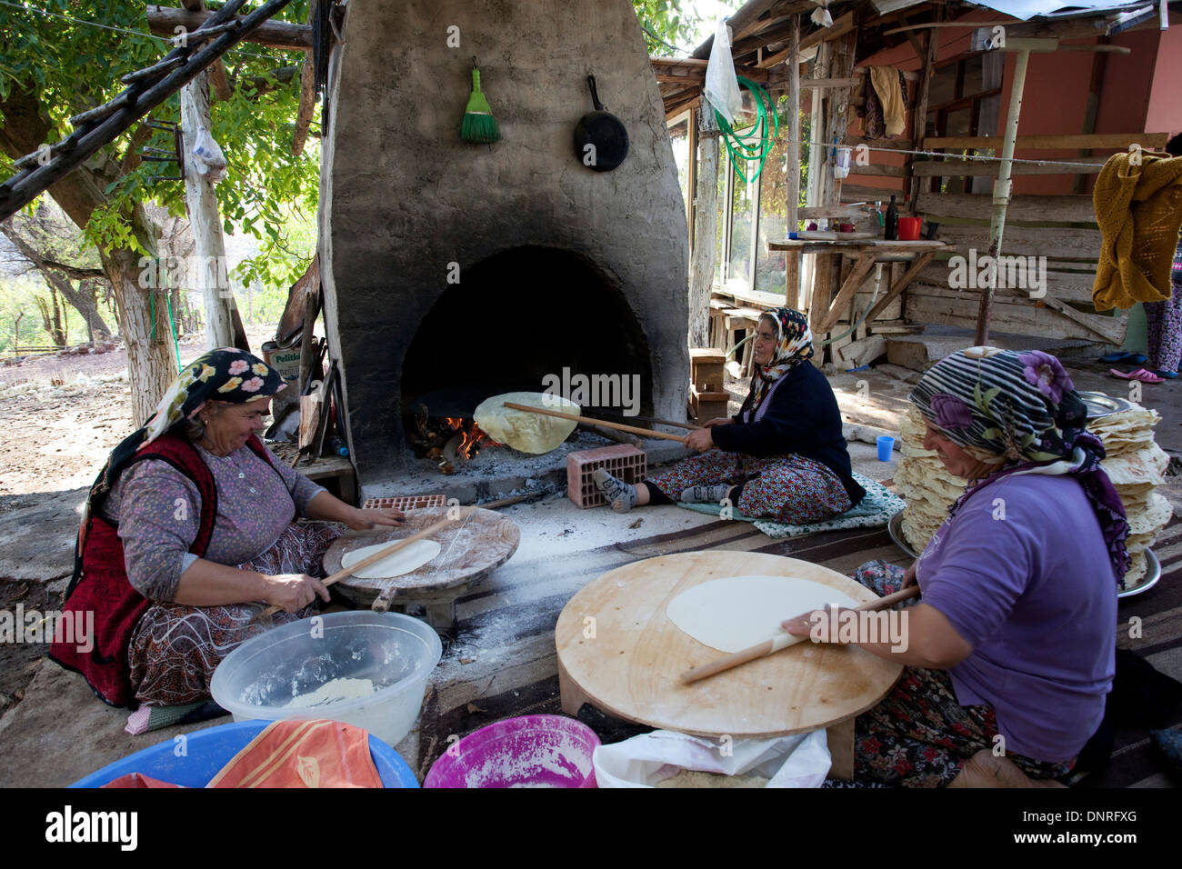 Women making traditional flat bread Oluklu Elmalı Antalya Turkey Stock ...