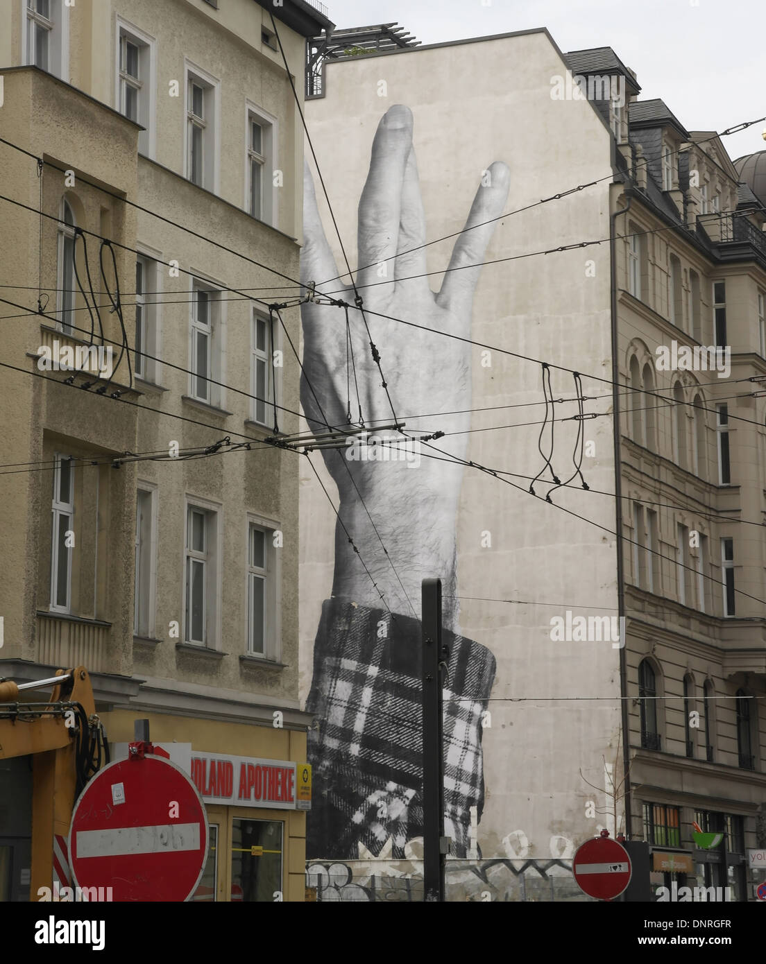 Tramway cables and 'Hand Making West Side Symbol', grey gable end ...