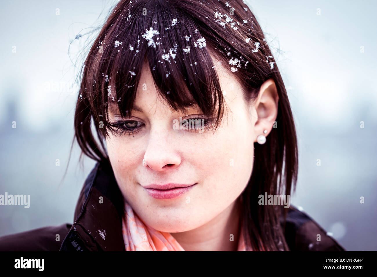 Unlucky young sad woman has a winter depression. She has snow in her ...