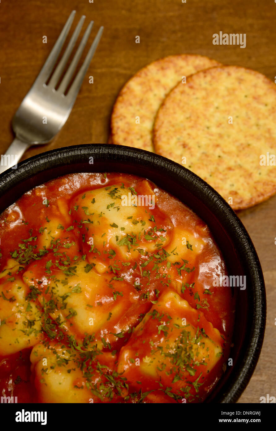 cheese ravioli with crackers and fork in rustic italian setting Stock ...