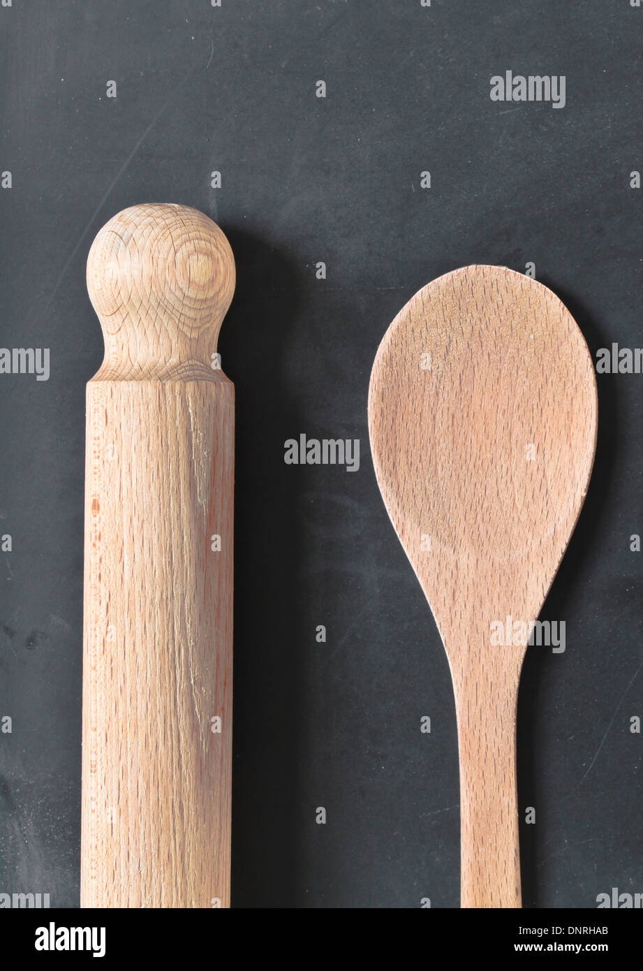 Wooden rolling pin and spoon on a black surgface Stock Photo - Alamy