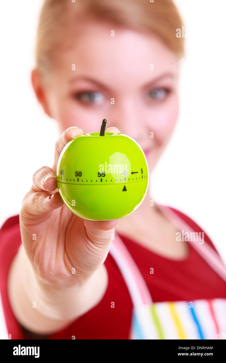 Happy housewife or chef in colorful kitchen showing apple timer ...