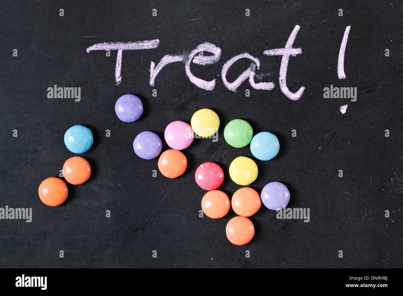 Colorful sweets and treat written on a black surface Stock Photo - Alamy