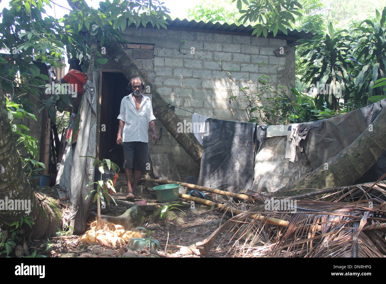 Kolonnawa, Sri Lanka. 18th Nov, 2013. Gunasiri (64) stands in front of ...