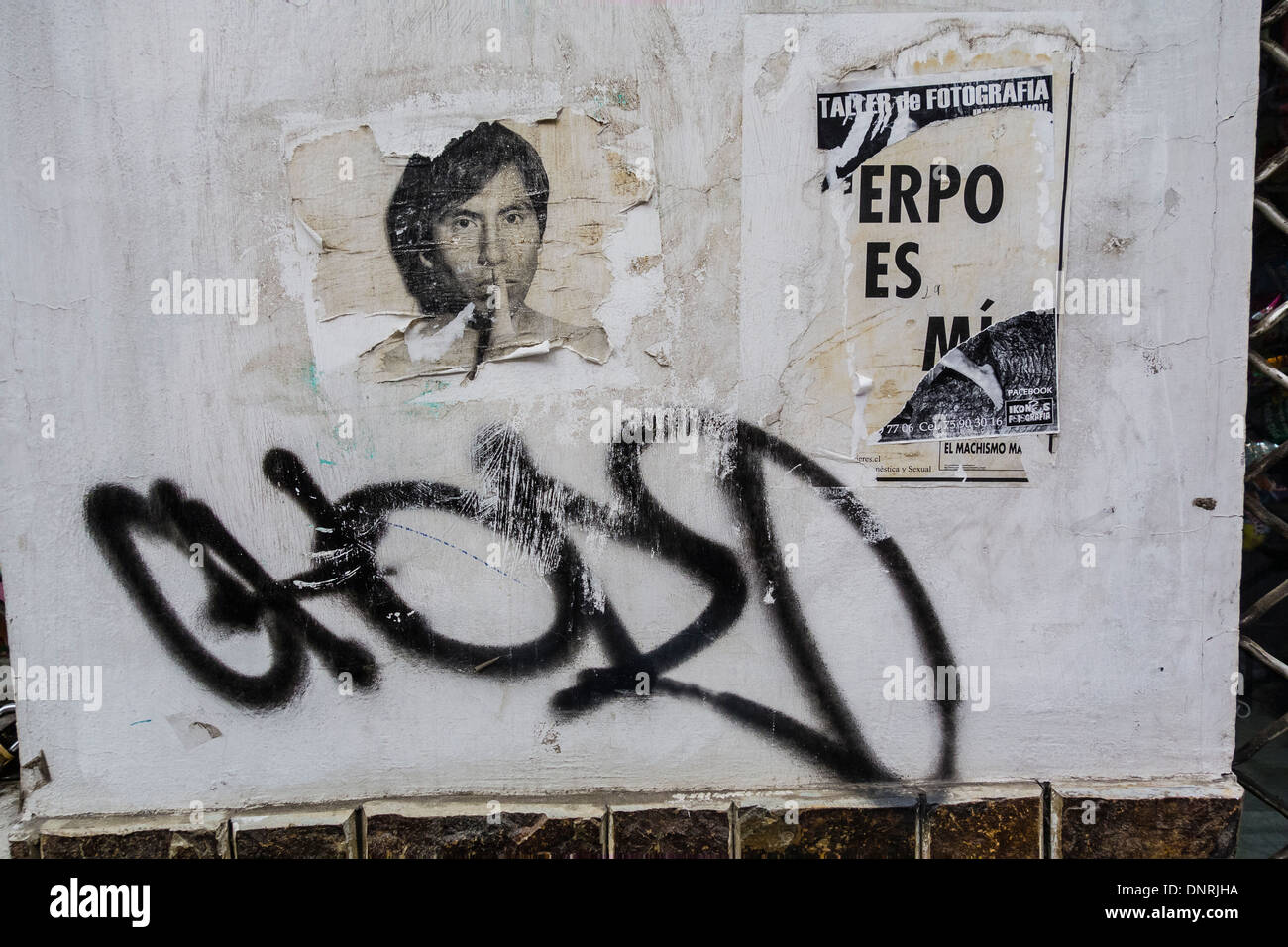 Tagged wall with graffiti and photograph of a man's face with his ...