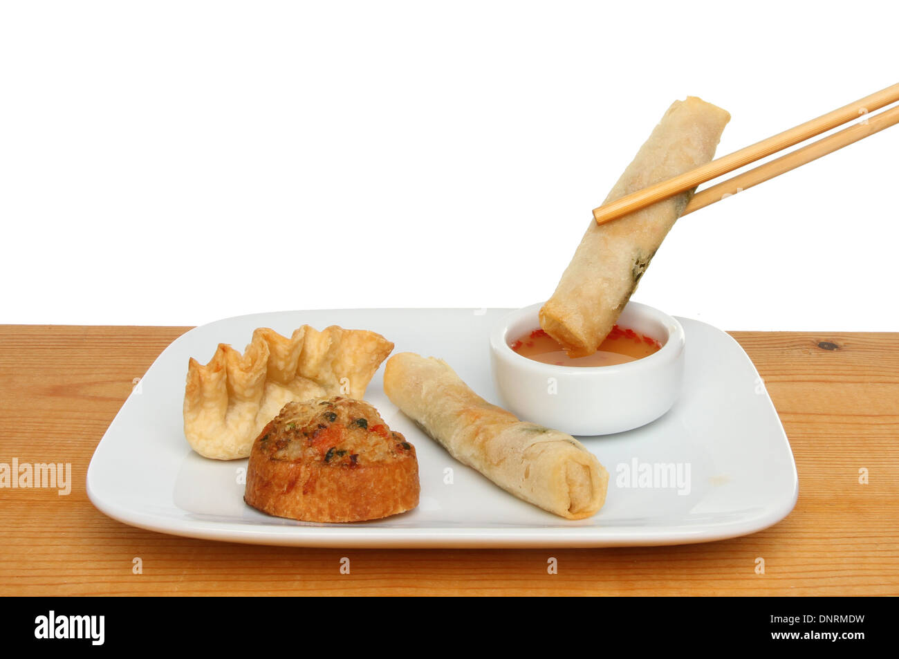 Chinese Dim Sum snacks on a plate with a pancake roll in chopsticks ...