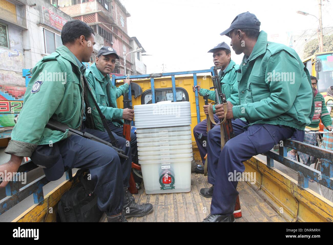 Dhaka, Bangladesh. 4th Jan, 2014. Bangladeshi police officials carry ...