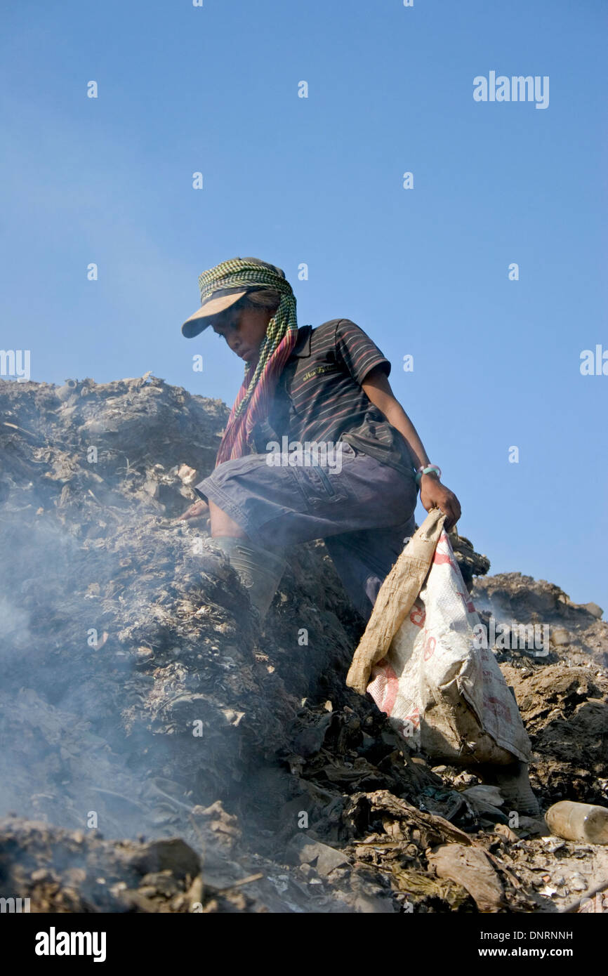A young child laborer girl is collecting recyclable material at the ...