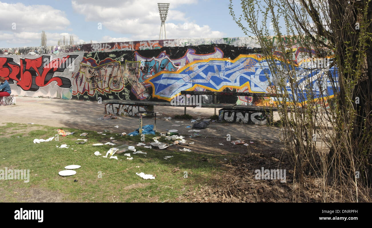 Litter on grass in front of Inner Berlin Wall (Hinterlandmauer) with ...