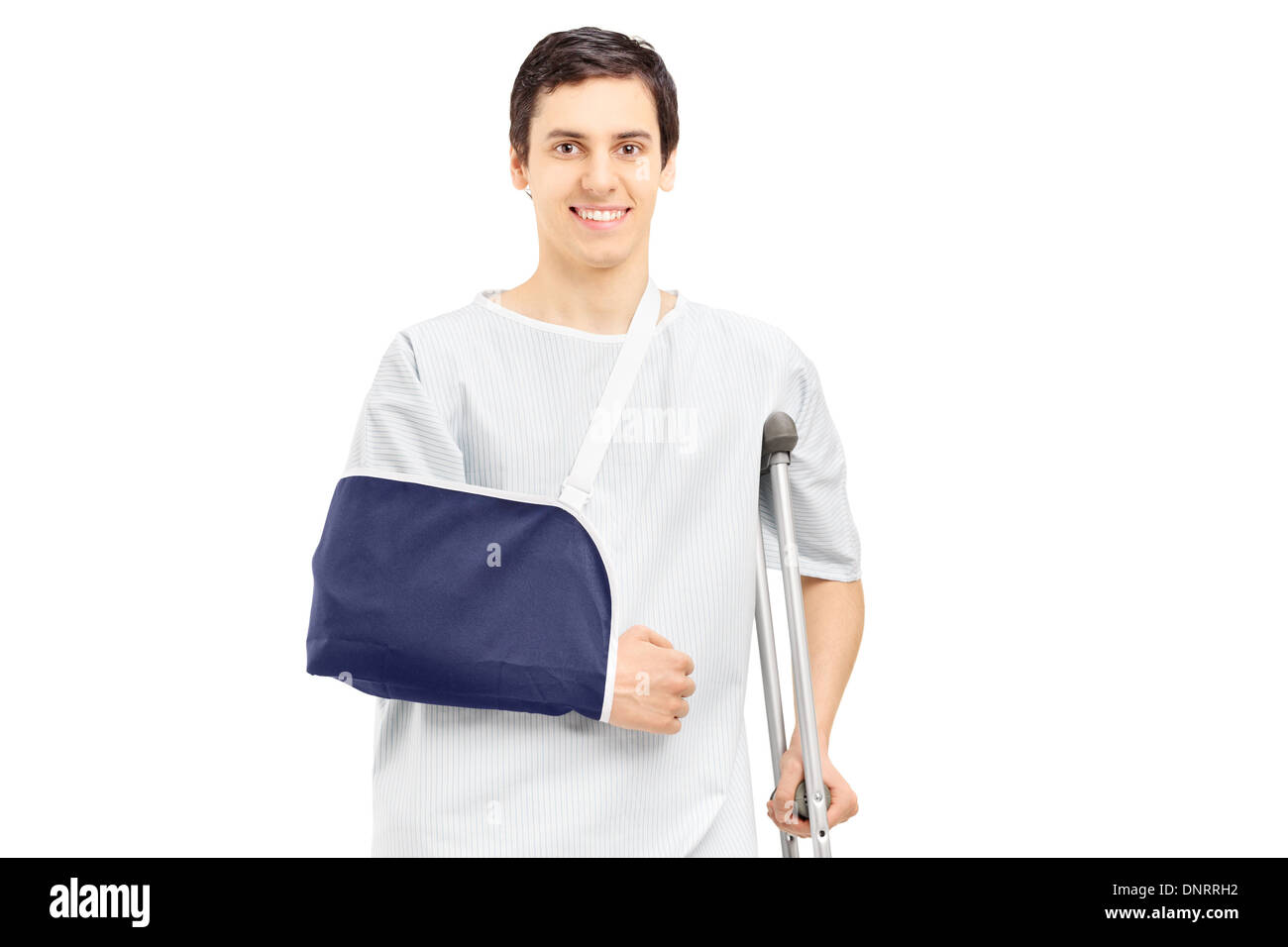Smiling male patient in hospital gown with broken arm Stock Photo - Alamy