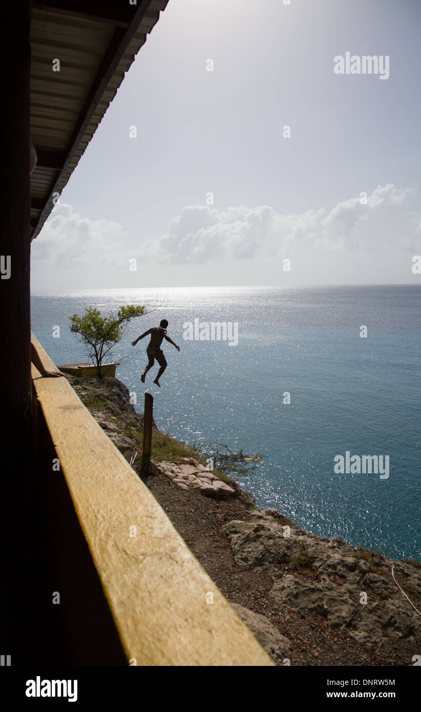 Man Jumping Off A Cliff Into The Sea High Resolution Stock Photography ...