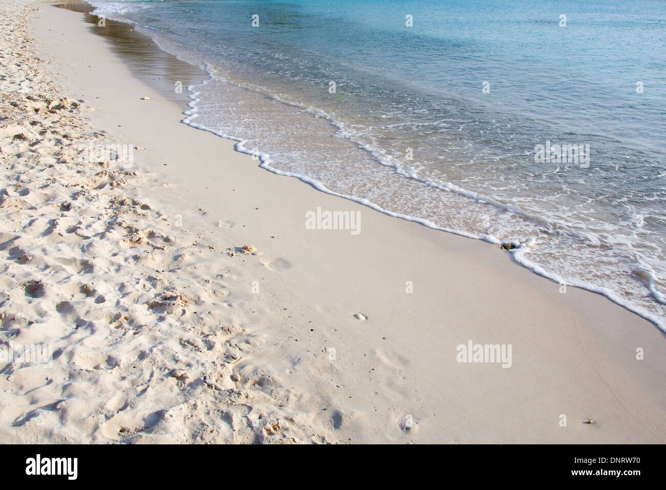 the water laps at the white sand beach on a tropical island Stock Photo ...