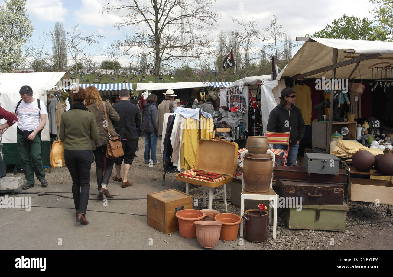 Sunny view people walking concrete pathway by canopy stall with plant ...