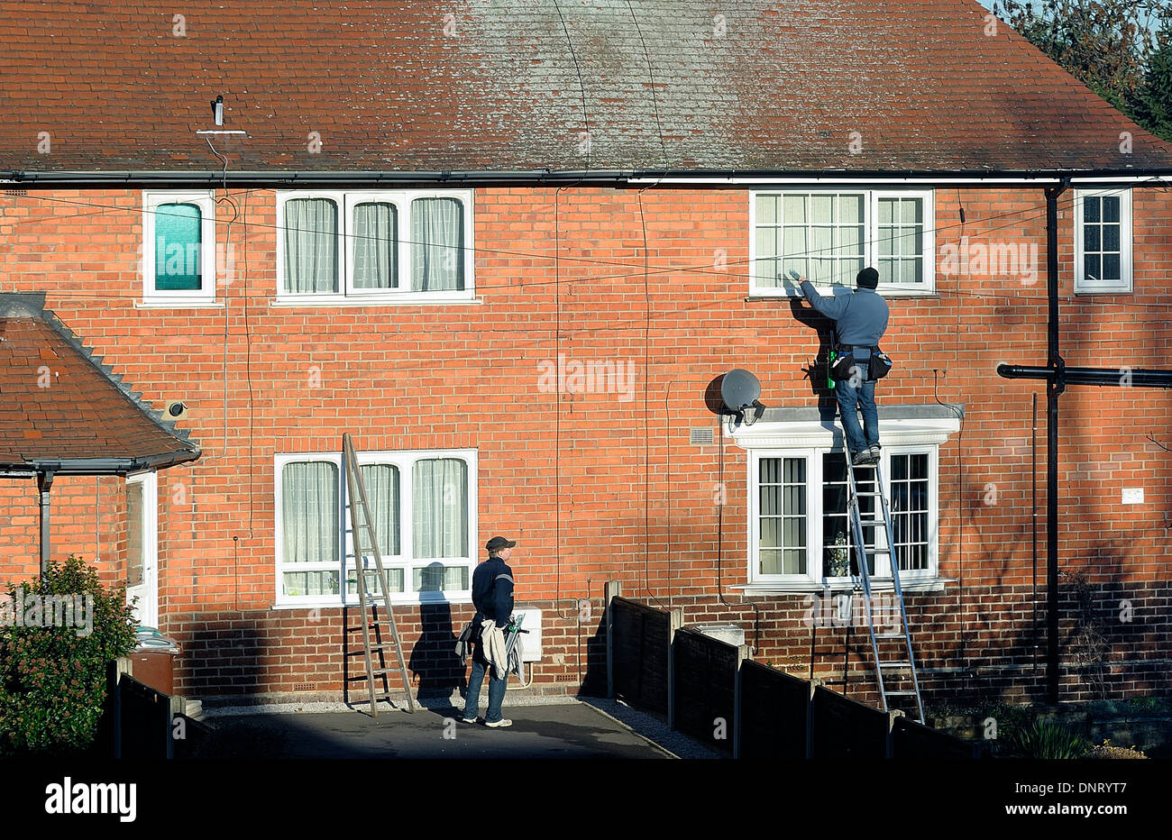 2 men, window cleaners cleaning windows England uk Stock Photo - Alamy