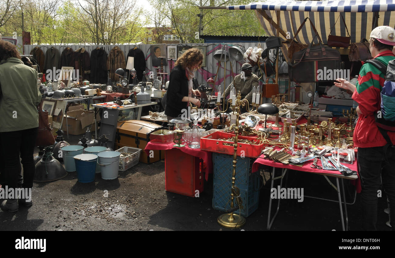 Sunny view, to stall with German helmets and lamps, people at stall ...