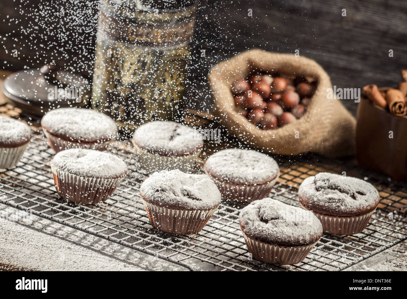 Falling icing sugar on fresh chocolate muffins Stock Photo - Alamy