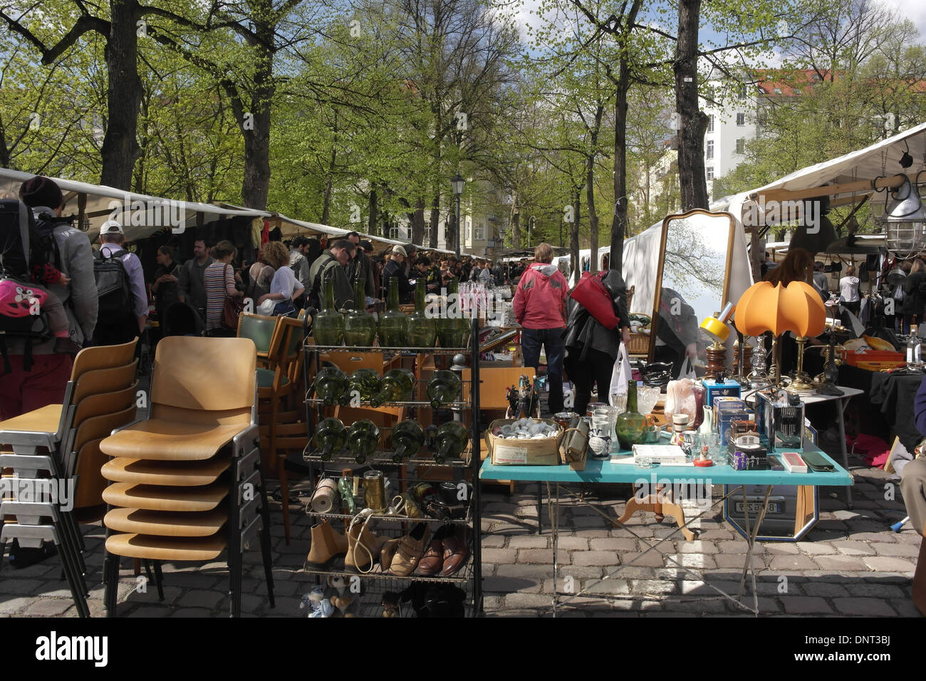 Sunny view household items stall and people at markets stalls ...