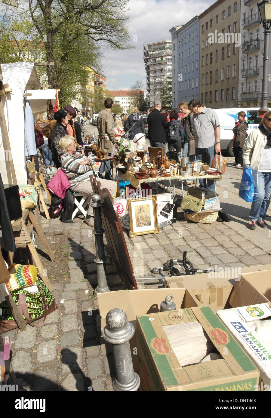 Sunny portrait people at Arkonaplatz Flea Market stalls standing stone ...