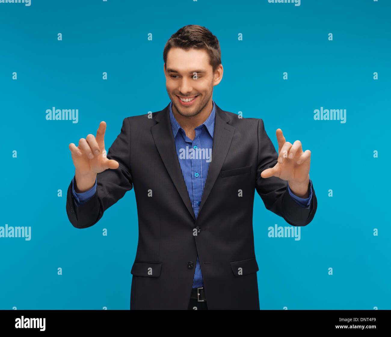 Businessman working something imaginary hi-res stock photography and ...