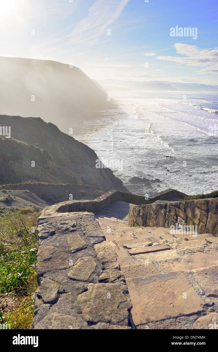 stone stairs to rocky beach with waves. Barrika, Basque Country Stock ...