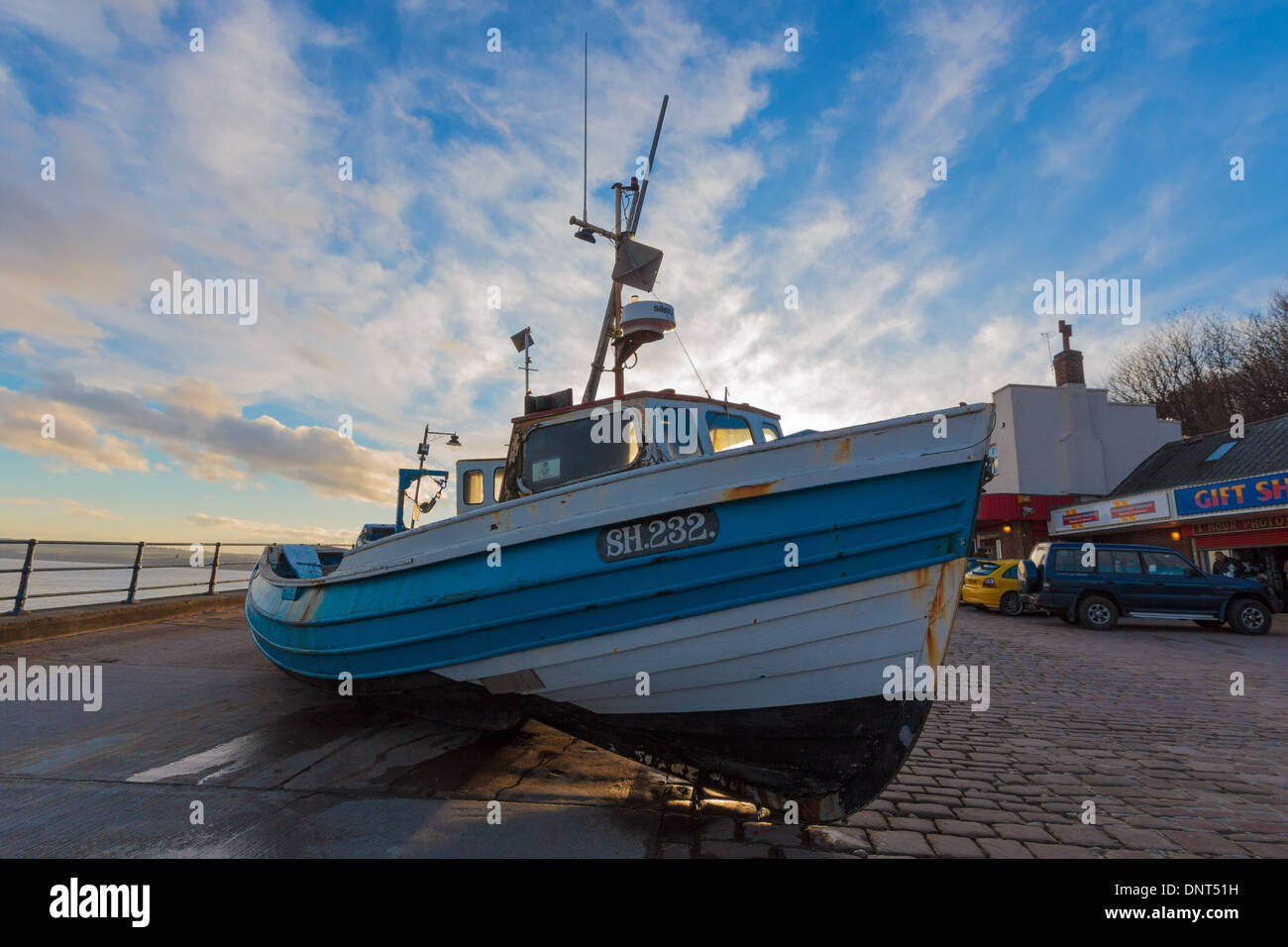 Fishing boat resting on Filey Harbour Stock Photo - Alamy
