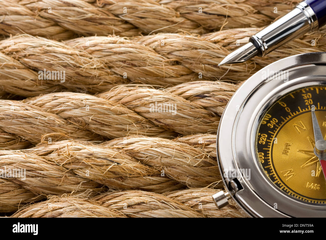compass with ink pen on ship ropes Stock Photo - Alamy