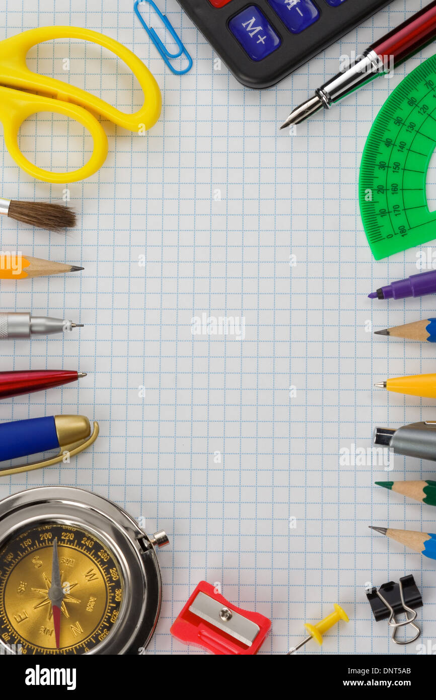 school supplies on checked notebook paper Stock Photo - Alamy