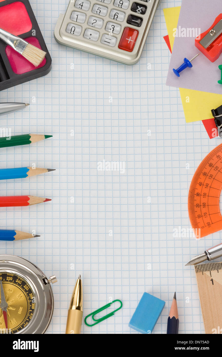 school supplies on checked notebook paper Stock Photo - Alamy