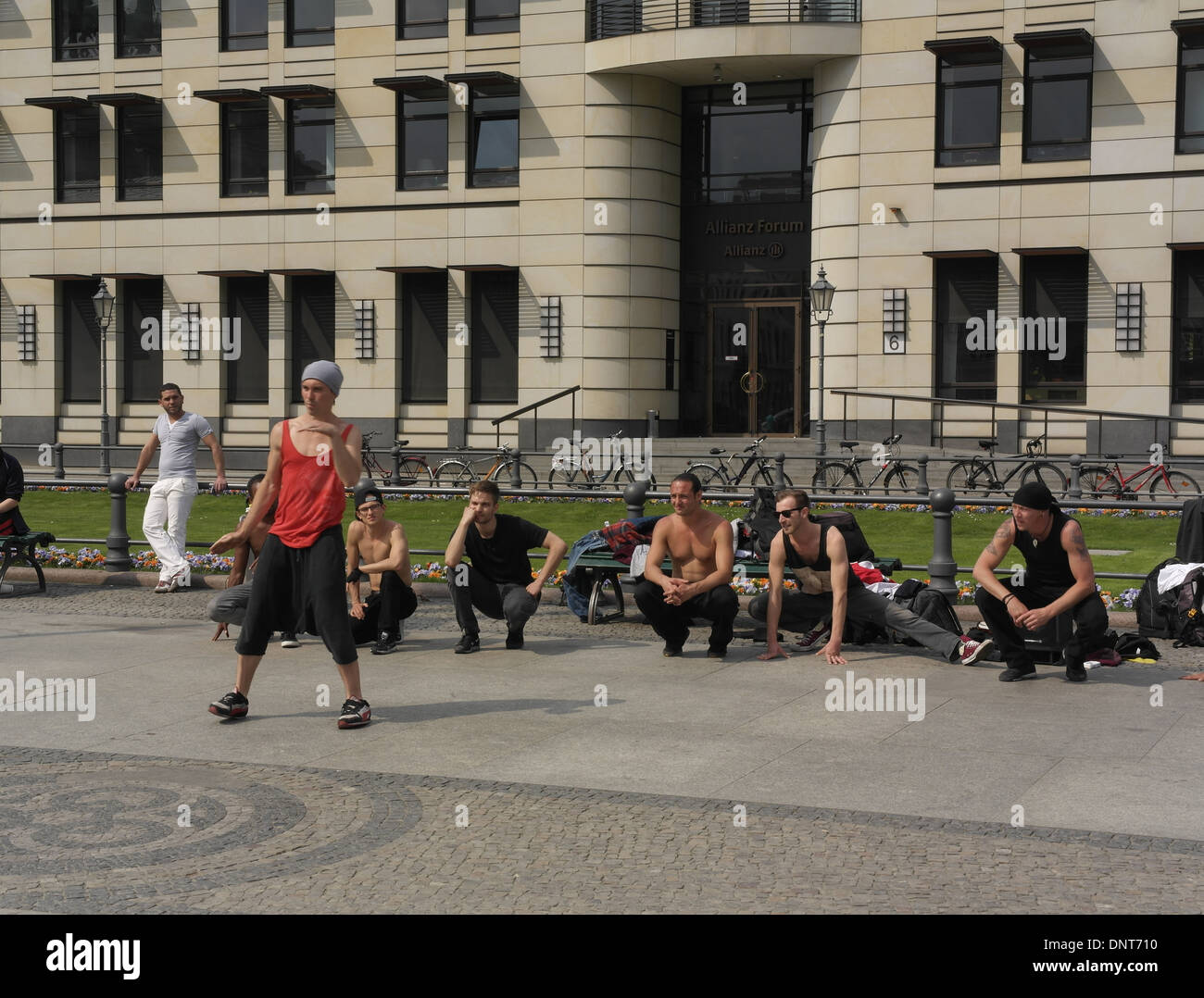 Sunny view 7 man dance group, men crouching, 1 red shirt man dancing ...