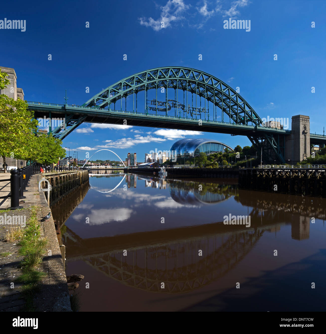 A daytime view of the Tyne Bridge reflected in the River Tyne as seen ...