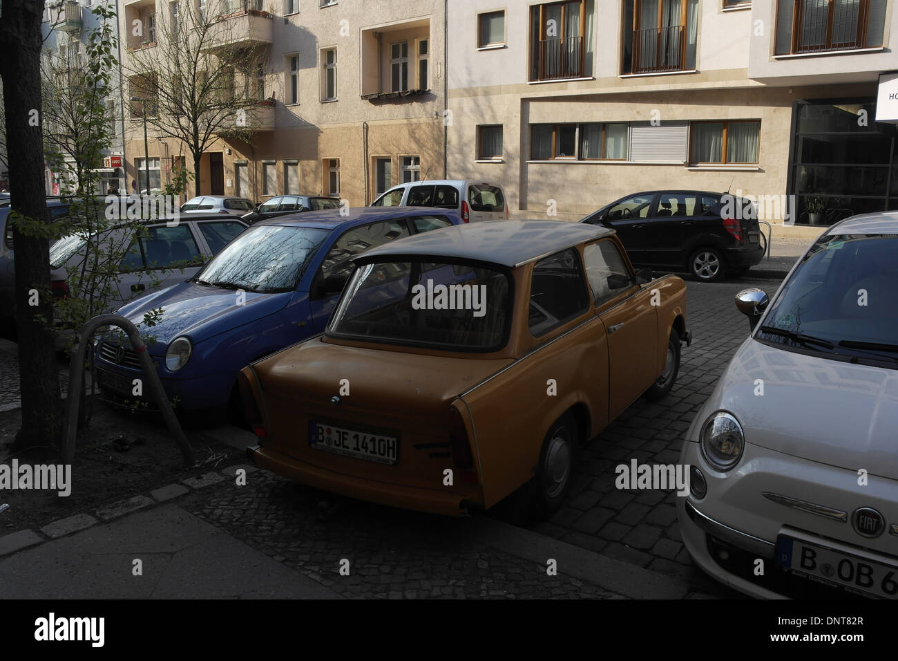 Roadside cars, with orange Trabant 601 next to white Fiat 500, parked ...