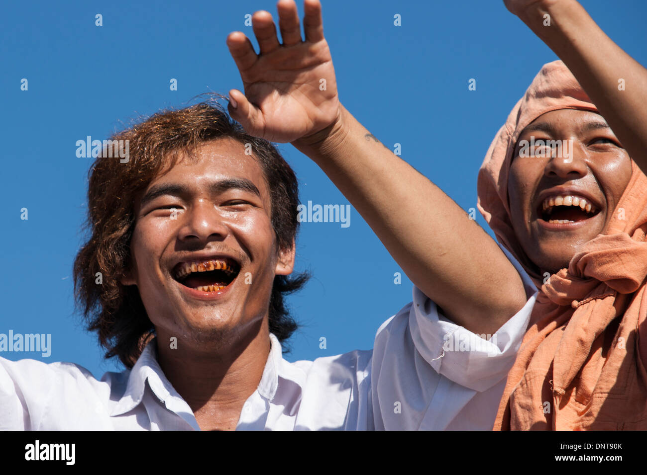 Two Burmese men dancing and enjoying the Paung Daw U Festival. Red ...