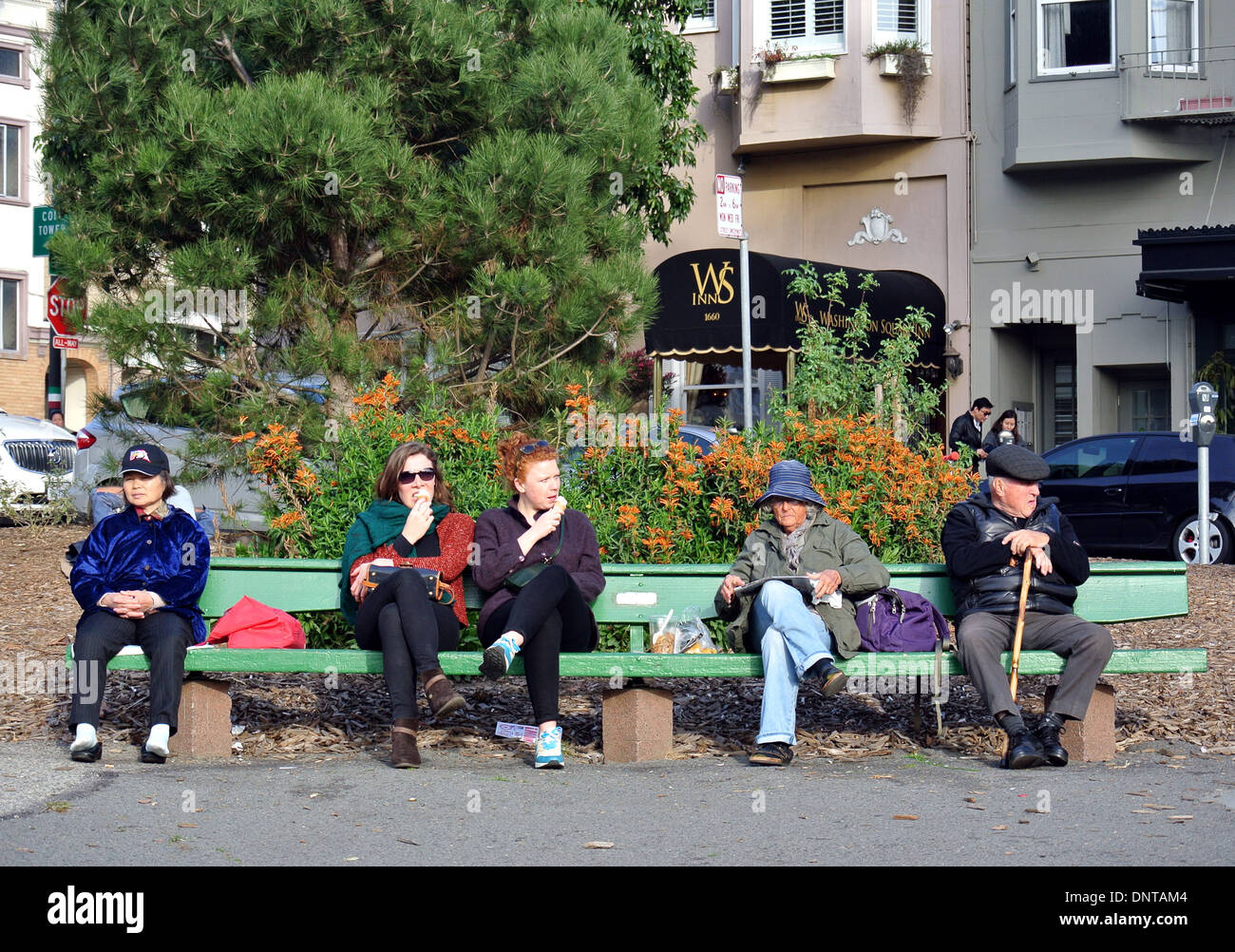 people sitting on a park bench in Washington Square in North Beach San ...