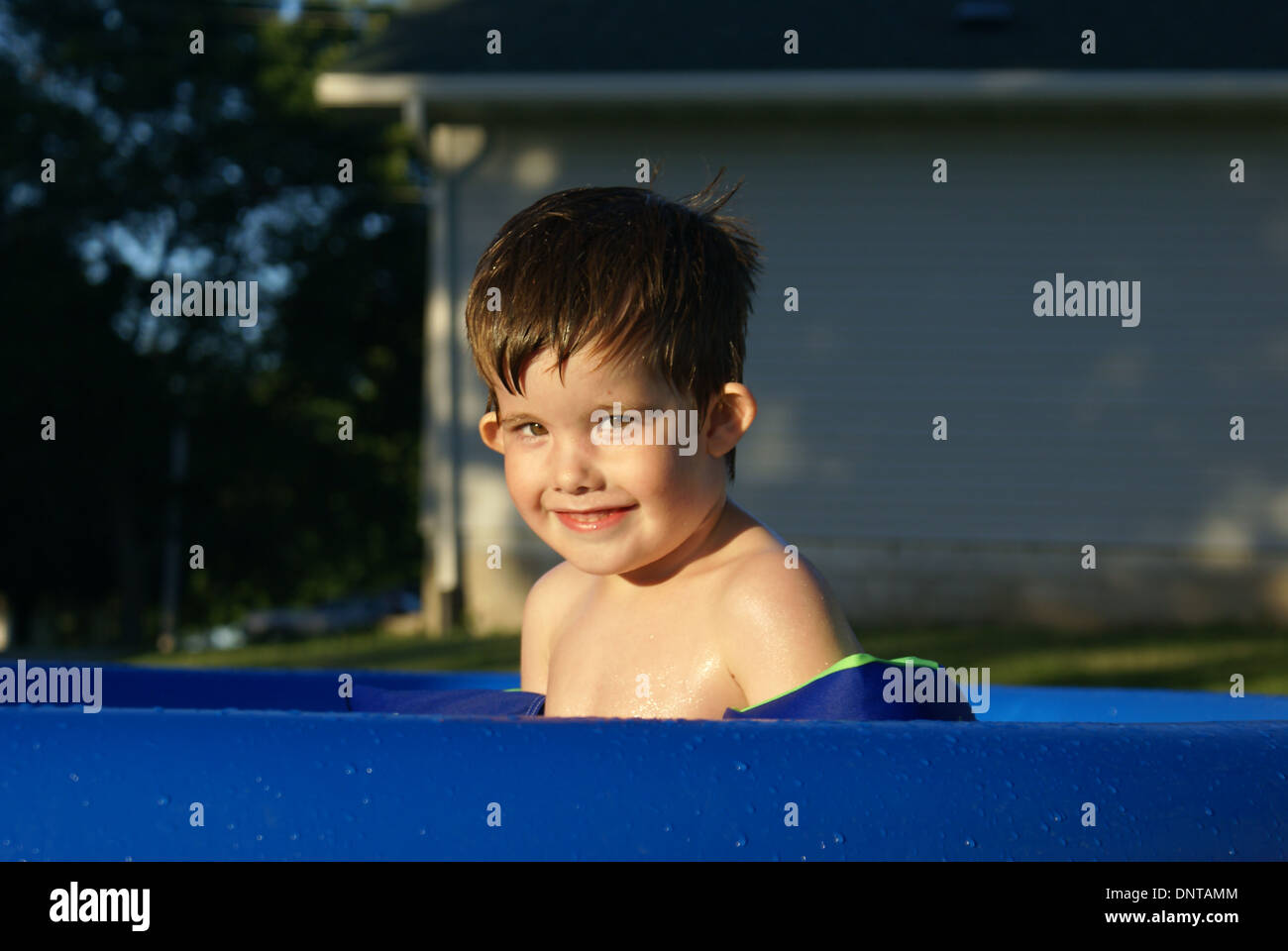 Cute little boy in a backyard swimming pool Stock Photo - Alamy
