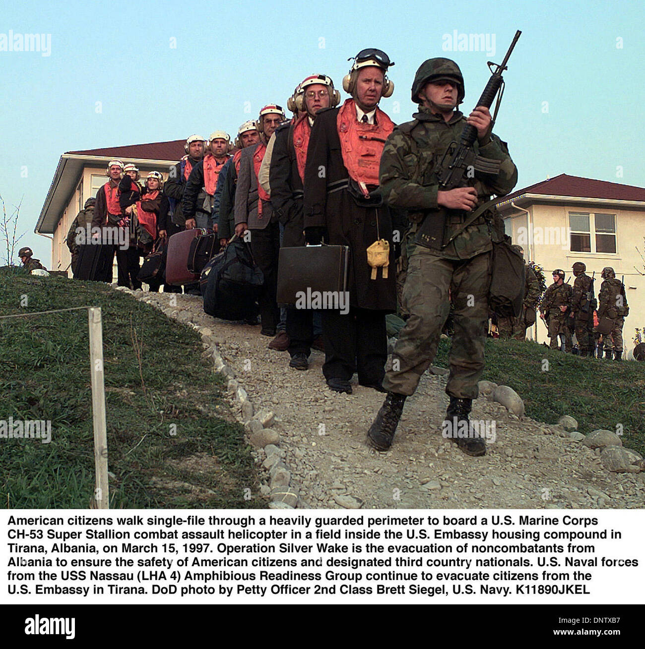 Mar. 15, 1997 - 970315-N-0000S-004..American citizens walk single-file ...