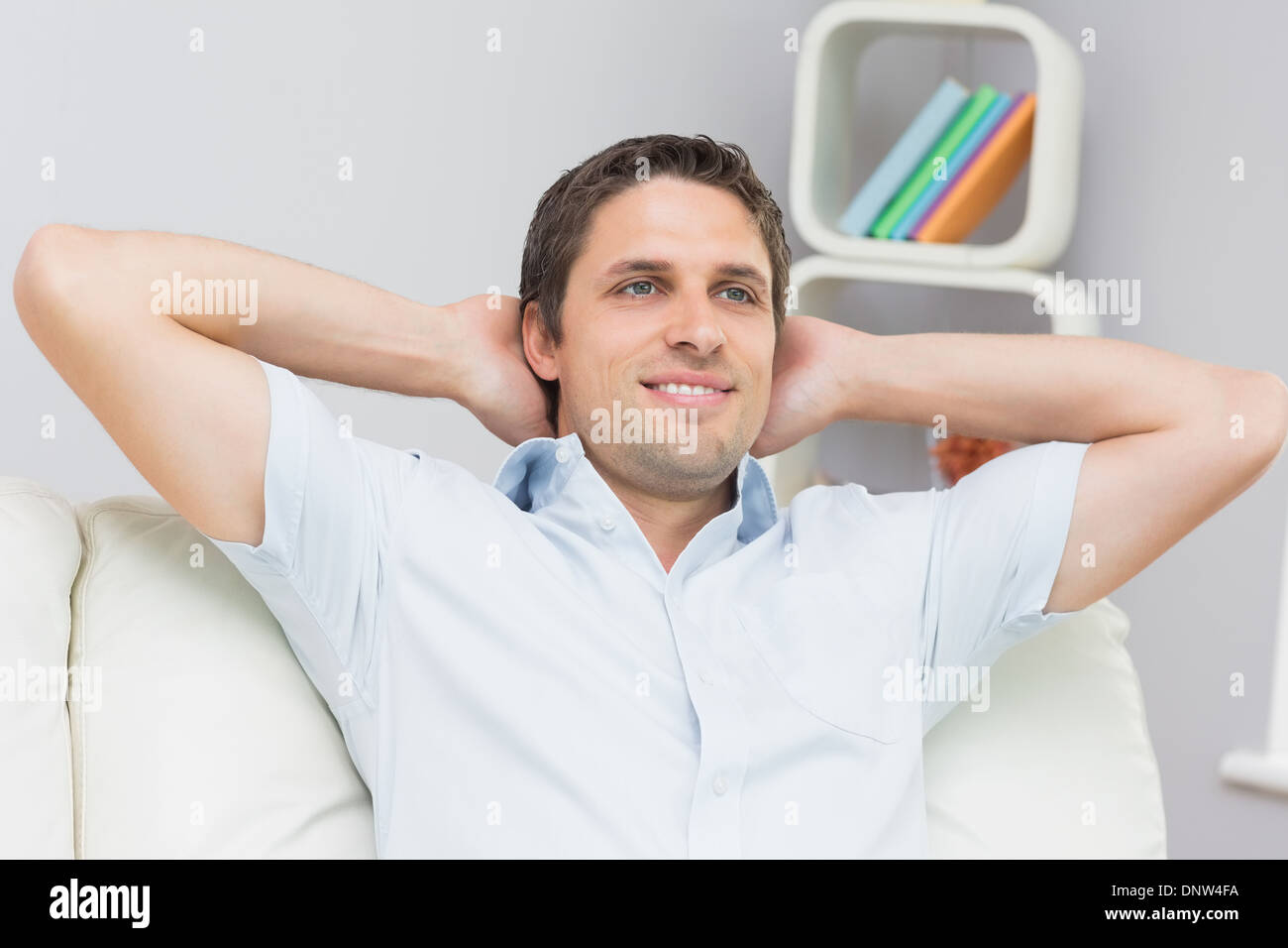Hands behind head man shirt hi-res stock photography and images - Alamy