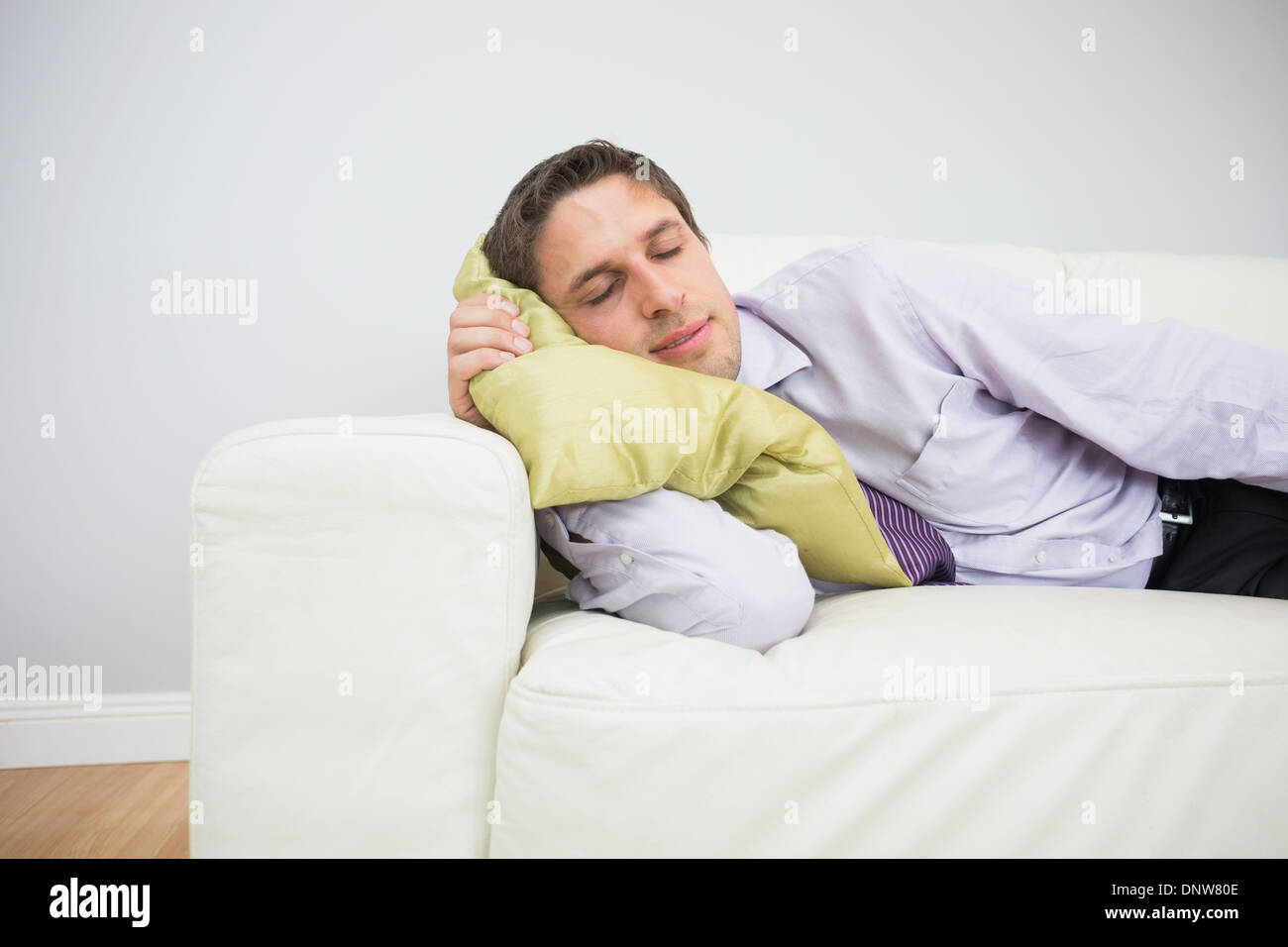 Tired businessman sleeping on sofa in living room Stock Photo - Alamy